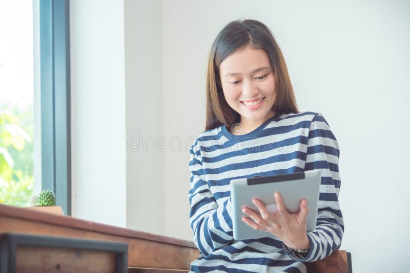 Woman Smiling while Using Tablet Computer Stock Image - Image of happy ...