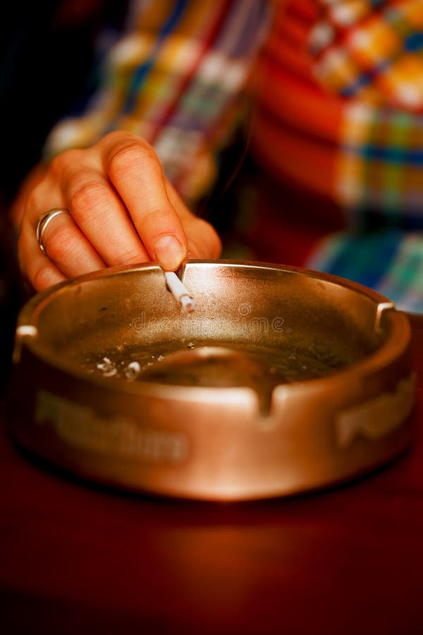 Woman Smoking Cigarette and Using an Ashtray, Cigarette in an Ashtray ...