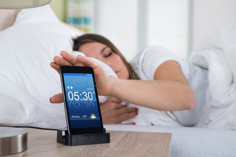 Man Snoozing Alarm Clock on Cell Phone Stock Image - Image of house ...