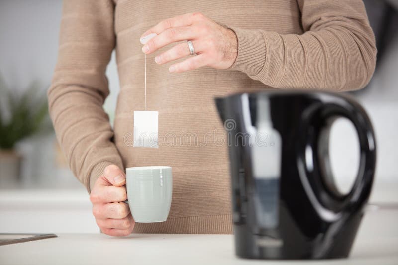 Woman Soaking Tea Bag in Grey Cup Stock Photo - Image of soaking, cafe ...