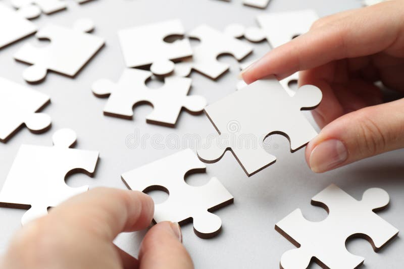 Woman Solving White Puzzle Light Grey Background Closeup Stock Photos ...