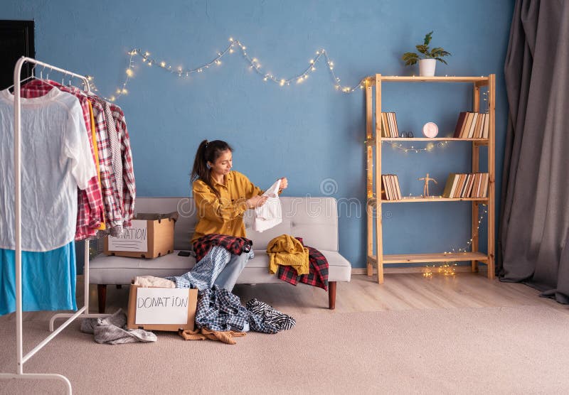 Woman Sorting and Packing Clothes on Donate Box in Her Room, Donation ...