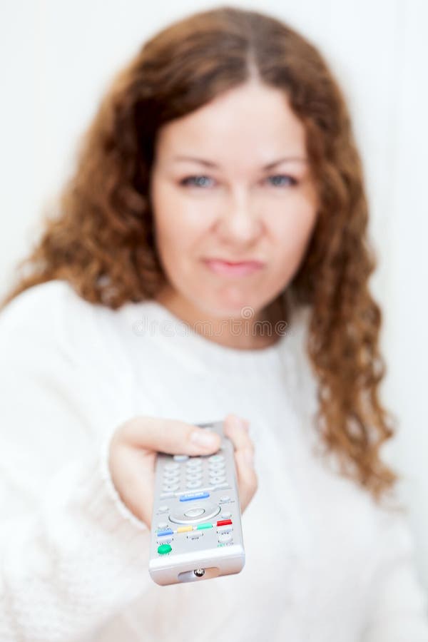 Woman with a Sour Face Changes Channels with Television Remote Stock ...
