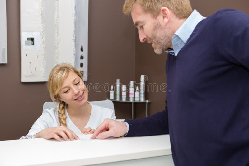 Woman in Spa Recpetion Talks To Customer Stock Image - Image of shop ...