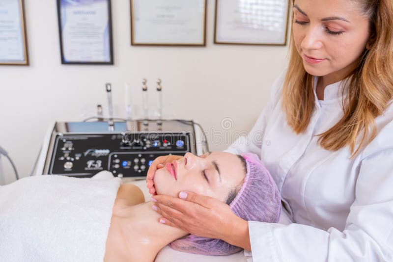 Woman In A Spa Salon Getting Face Massage For Facial Care Beautician