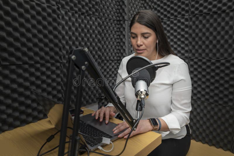 Woman Speaking into a Microphone in an Audio Booth, while Recording a ...