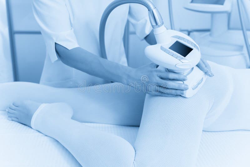 Woman In Special White Suit Getting Anti Cellulite Massage For Legs In