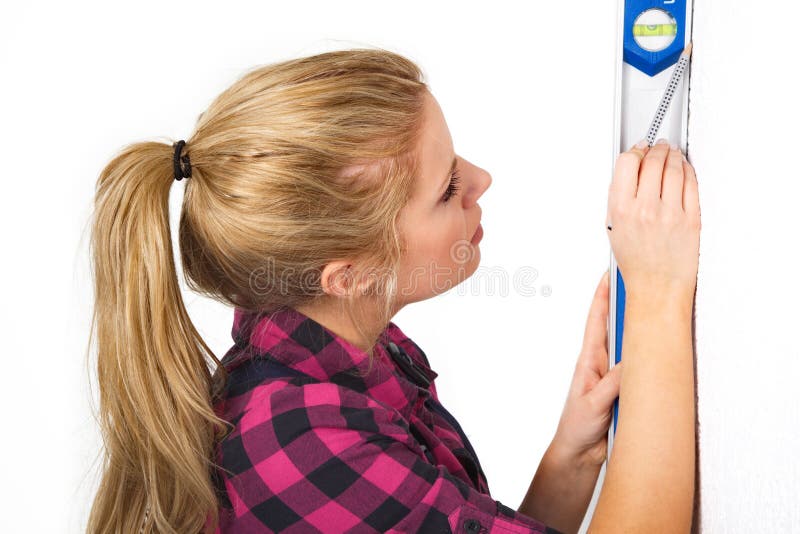 Woman with a spirit level stock photo. Image of equipment - 39800410
