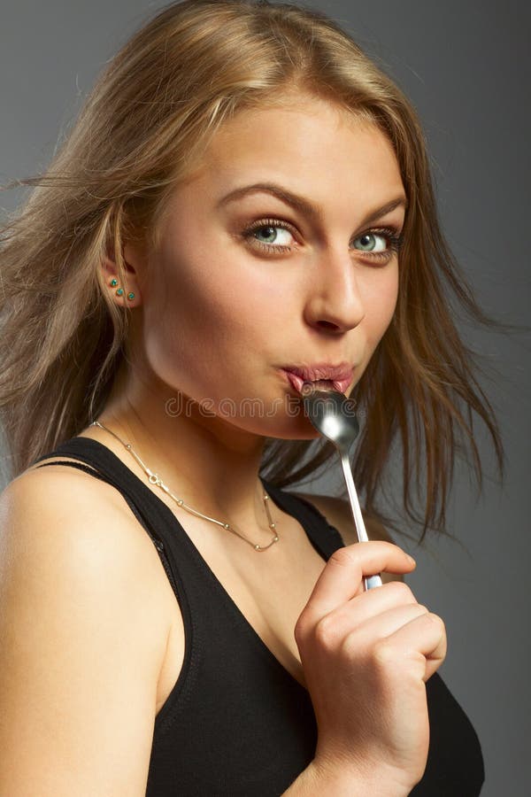 Woman with a Spoon in Mouth Stock Photo - Image of attractive, mouth ...