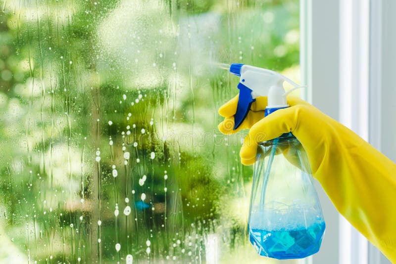 Woman Spraying and Wiping Glass Stock Photo - Image of housekeeping ...
