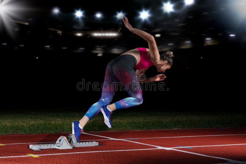 Woman Sprinter Leaving Starting Blocks on the Athletic Track. Exploding ...