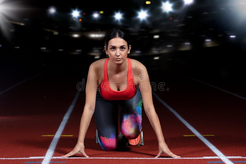 Woman Sprinter Leaving Starting Blocks on the Athletic Track. Exploding ...
