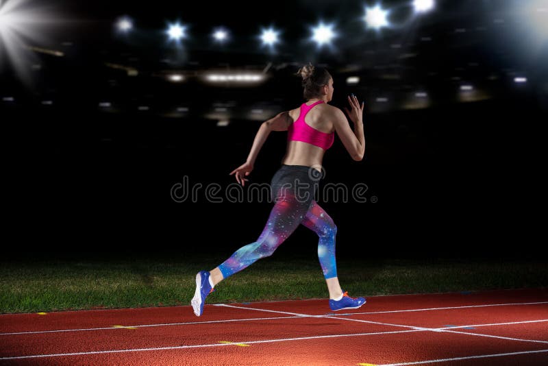 Woman Sprinter Leaving Starting Blocks on the Athletic Track. Exploding ...