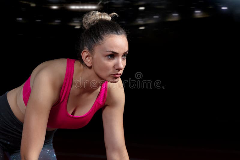 Woman Sprinter Leaving Starting Blocks on the Athletic Track. Exploding ...