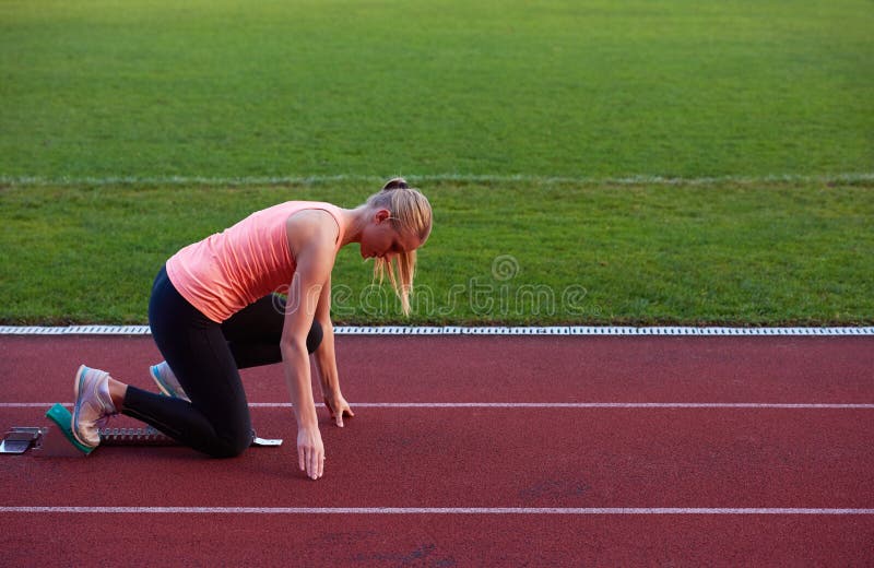 Woman Sprinter Leaving Starting Blocks Stock Photo - Image of energy ...