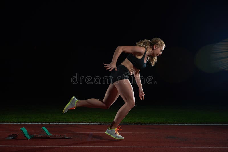 Woman Sprinter Leaving Starting Blocks Stock Photo - Image of motion ...