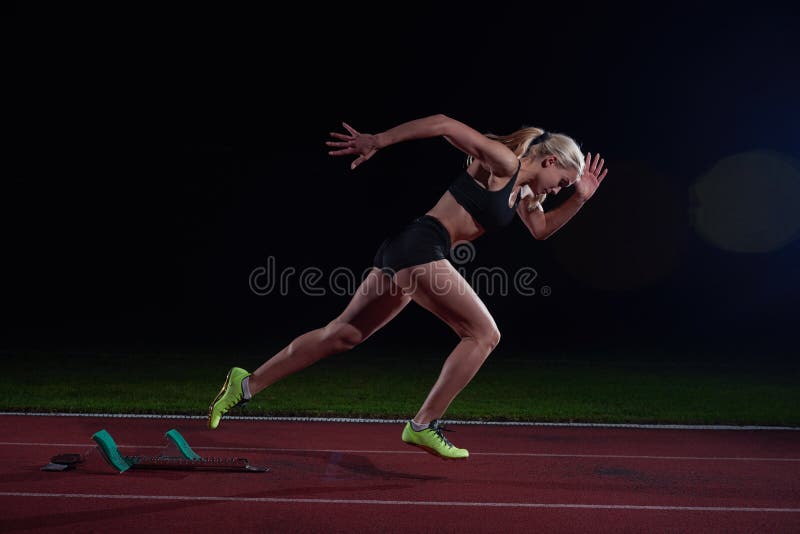 Woman Sprinter Leaving Starting Blocks Stock Photo - Image of adult ...