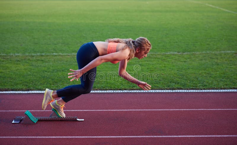 Woman Sprinter Leaving Starting Blocks Stock Photo - Image of athlete ...