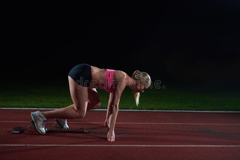 Woman Sprinter Leaving Starting Blocks Stock Image - Image of muscular ...