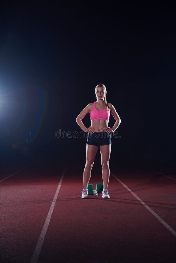 Woman Sprinter Leaving Starting Blocks Stock Photo - Image of adult ...