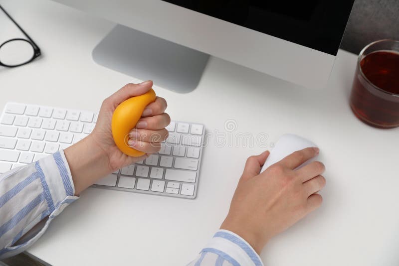 Woman Squeezing Antistress Ball while Working on Computer in Office ...