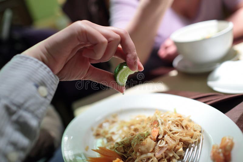 Woman Squeezing Lime Over Dish Stock Photo - Image of dish, indoor ...
