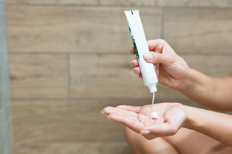 Woman Squeezing Lotion Onto Her Hand in the Shower Stock Photo - Image ...
