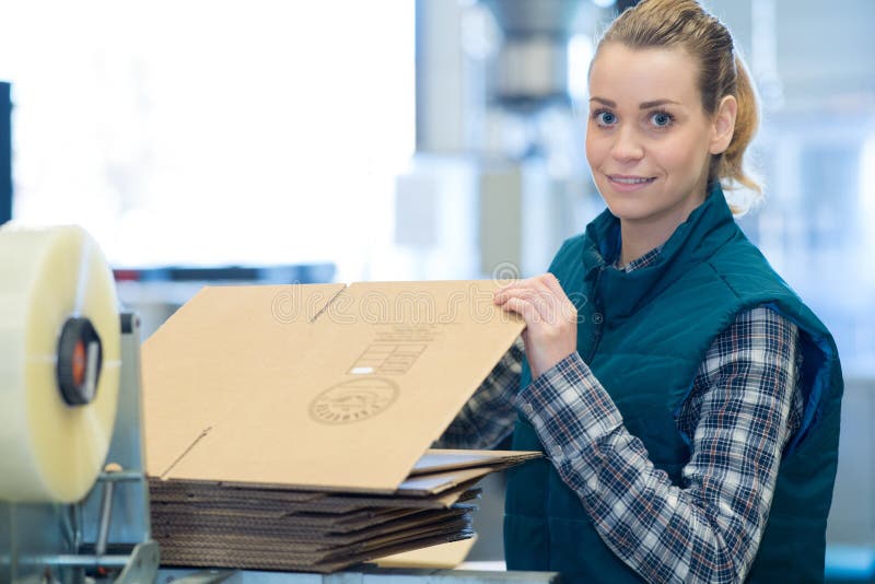 Woman with Stack Flatpacked Boxes in Factory Stock Photo - Image of ...
