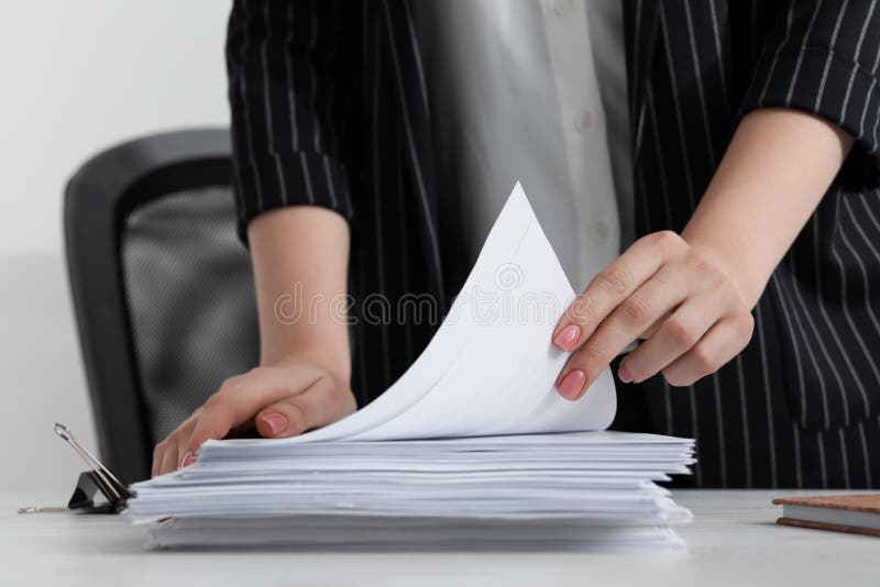 Woman Stacking Documents at White Wooden Table in Office, Closeup Stock ...