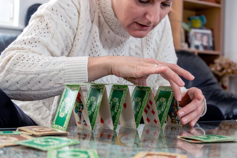 Woman Stacking a Tower from Playing Cards. Stock Image - Image of ...