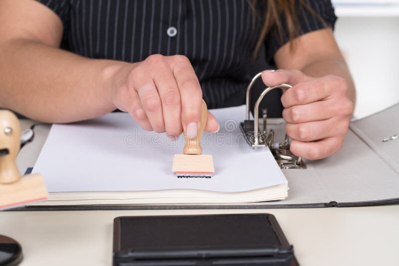 Woman stamping documents stock image. Image of public - 20490145