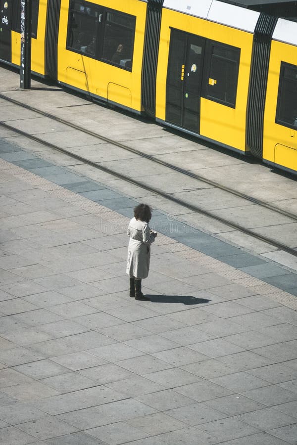 Woman Standing Alone on the Street in Front of Tramway / Tram Tr Stock ...