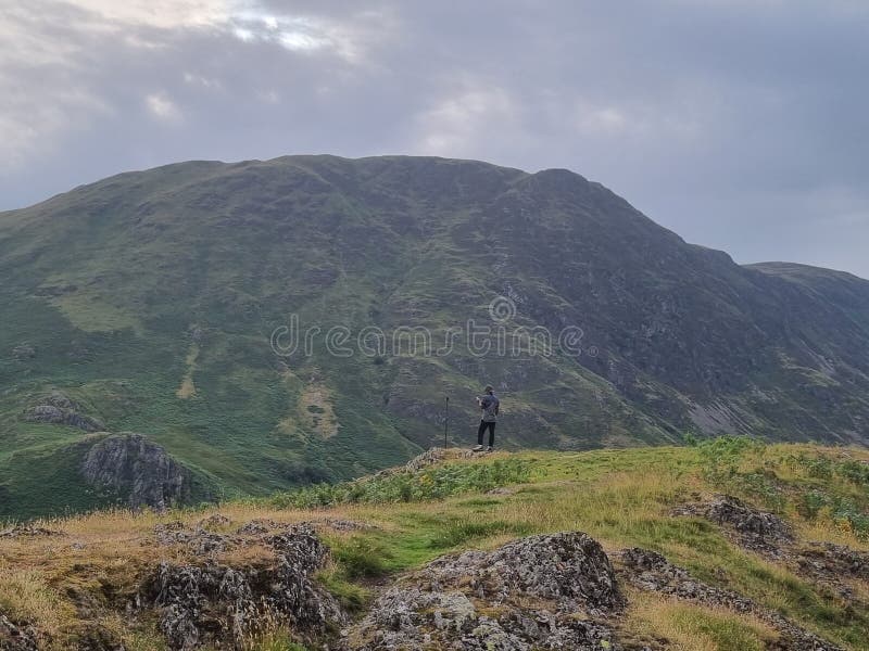 Woman Standing by a Cliff Overlooking the Mountains Stock Photo - Image ...