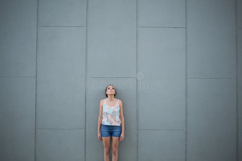 Woman Standing in Front of Grey Wall Stock Image - Image of view ...