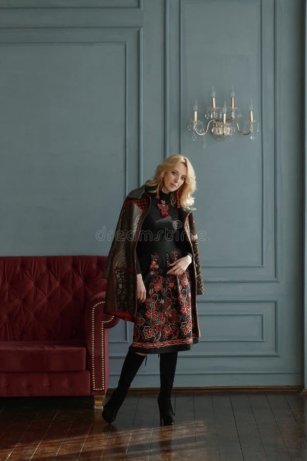 Woman Standing in Front of Red Couch Stock Photo - Image of beautiful ...