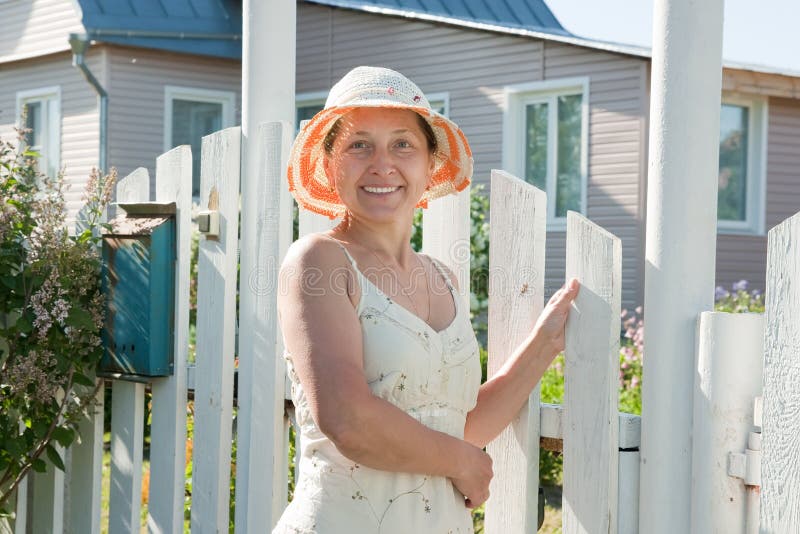 Woman Standing at the Gate of House Stock Image - Image of 4050 ...