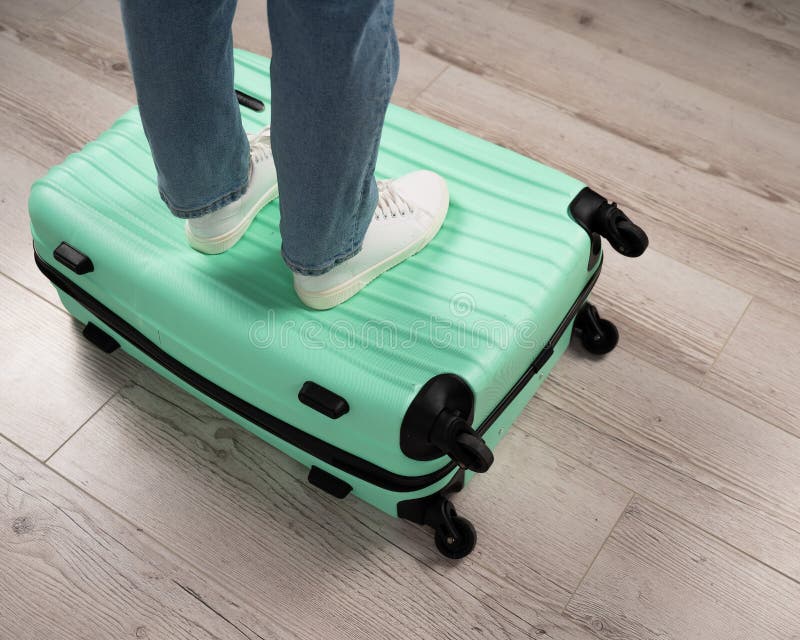 Woman Standing with Her Feet on a Suitcase. Stock Image - Image of ...