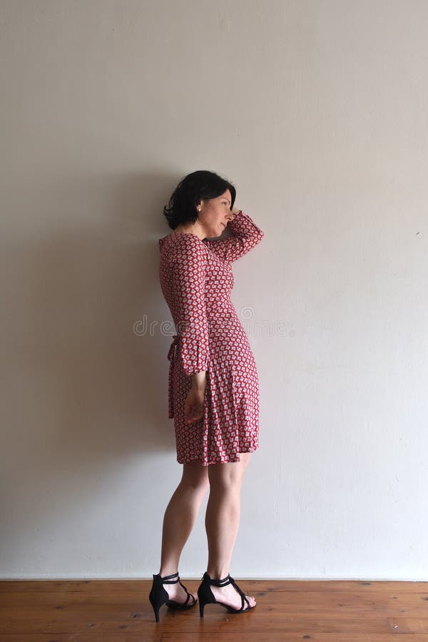 Woman Standing Leaning on a White Wall Stock Photo - Image of looking ...