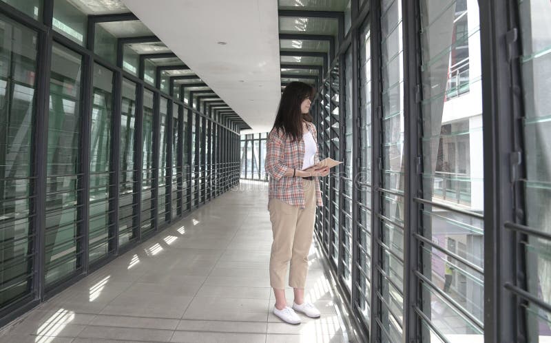 Woman Standing and Looking Out the Windows Stock Photo - Image of ...