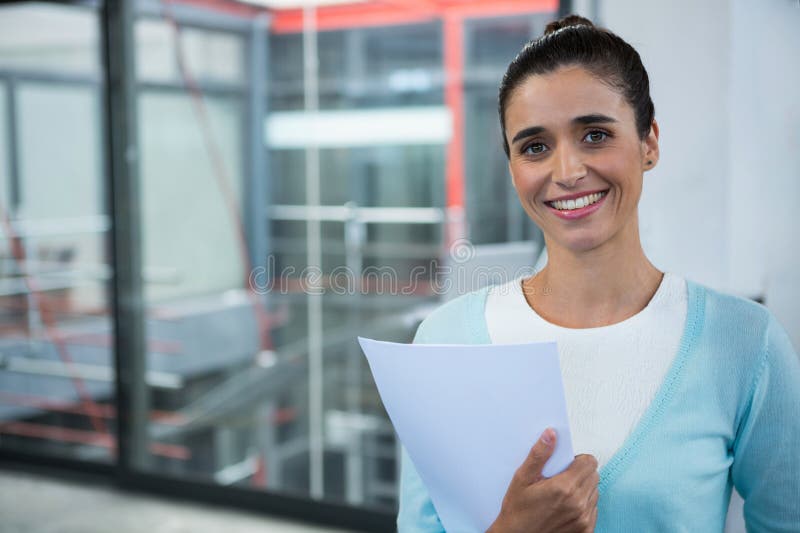 Woman Standing in Modern Office Interior Holding White Documents and ...