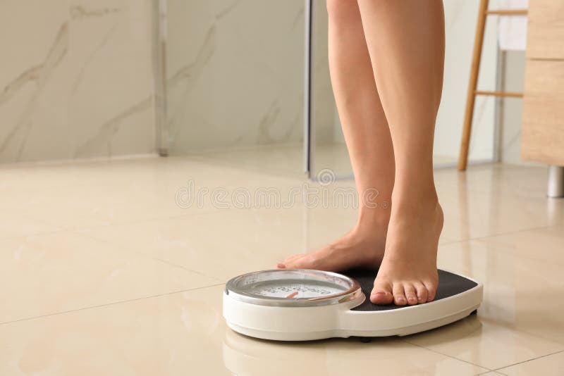 Woman Standing On Scales In Bathroom For Text Overweight Problem