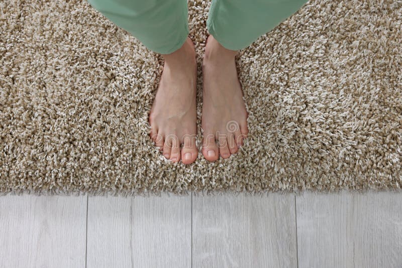 Woman Standing on Soft Light Brown Carpet at Home, Top View Stock Image ...