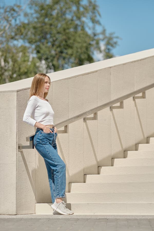 Woman Standing on Stairs in Profile Stock Photo - Image of looking ...