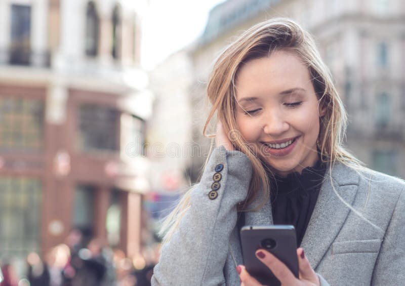 Woman Standing at the Street and Using Mobile Phone Stock Photo - Image ...