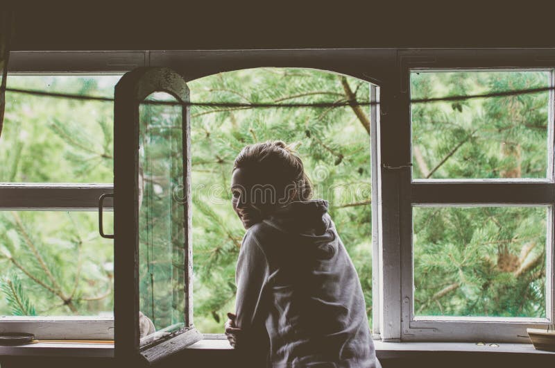 A Woman Standing by the Window Admires a View of Nature in the Stock ...