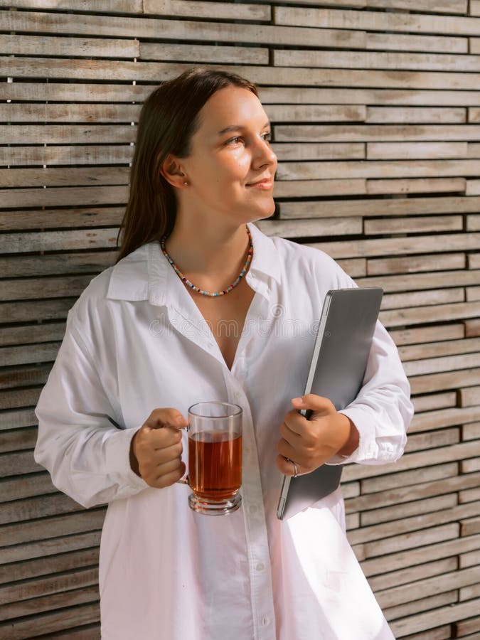 Woman Staying with Laptop and Holding Cup of Tea Stock Photo - Image of ...