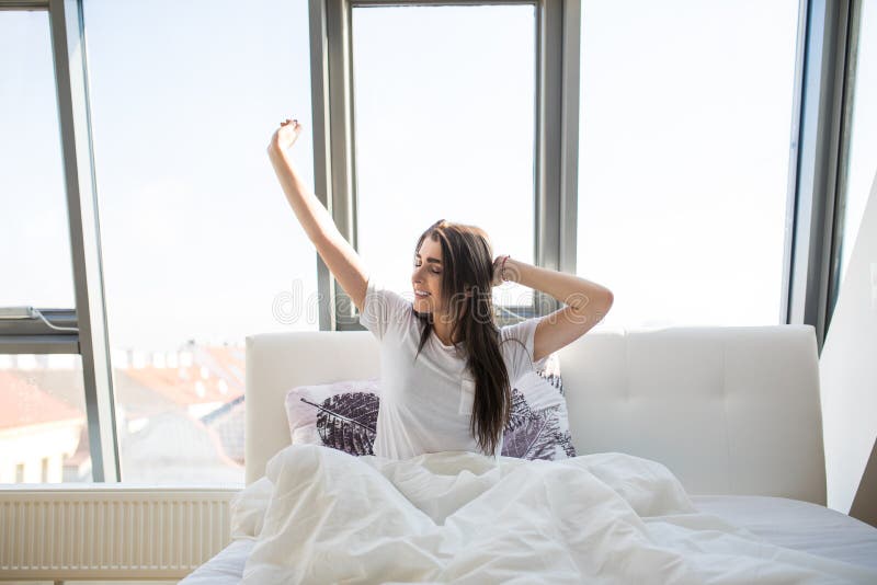 Woman stretching in bed stock image. Image of beautiful - 83139653