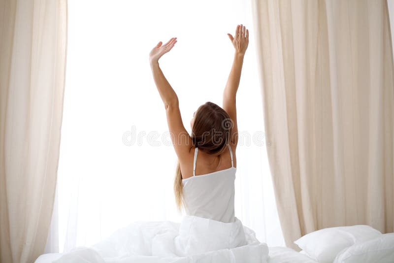 Woman Stretching In Bed After Wake Up Back View Entering A Day Happy