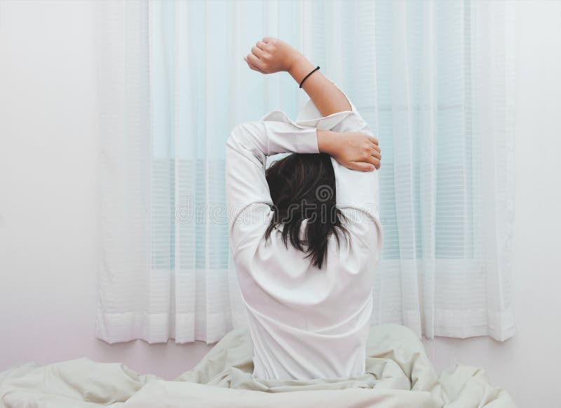 Woman Stretching in Bed after Waking Up, Back View Stock Photo - Image ...