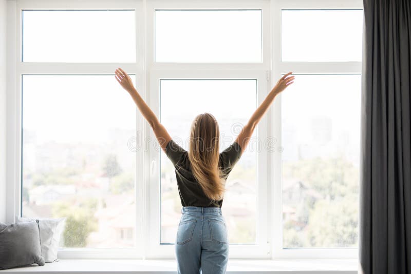 Young Woman Stretching in Bed after Waking Up, Back View Stock Photo ...